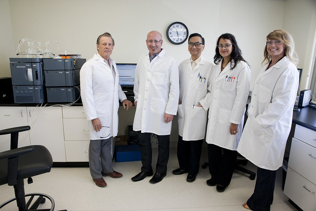 Gary in lab with other scientists | D. Gary Young